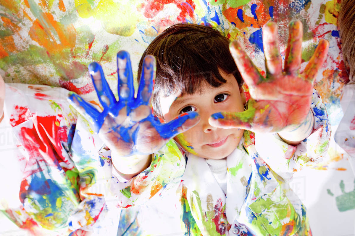 Messy Hispanic boy finger painting - Royalty-free Stock Photo | Dissolve
