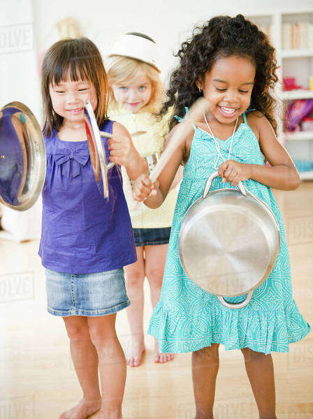 Girls making music with pots and pans - Royalty-free Stock Photo | Dissolve