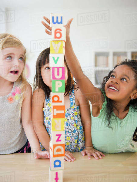 Girls stacking alphabet blocks together - Royalty-free Stock Photo ...