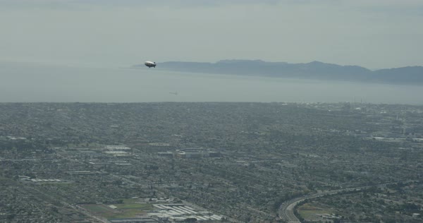 Helicopter aerial shot of blimp over town, overcast day - 4K Royalty ...