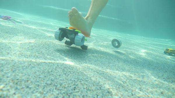 Woman stumbles on toys walking on the bottom of a pool - 4K Royalty ...