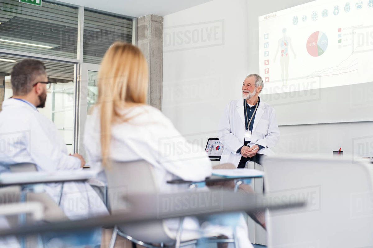 A group of doctors listening to presentation on medical conference ...