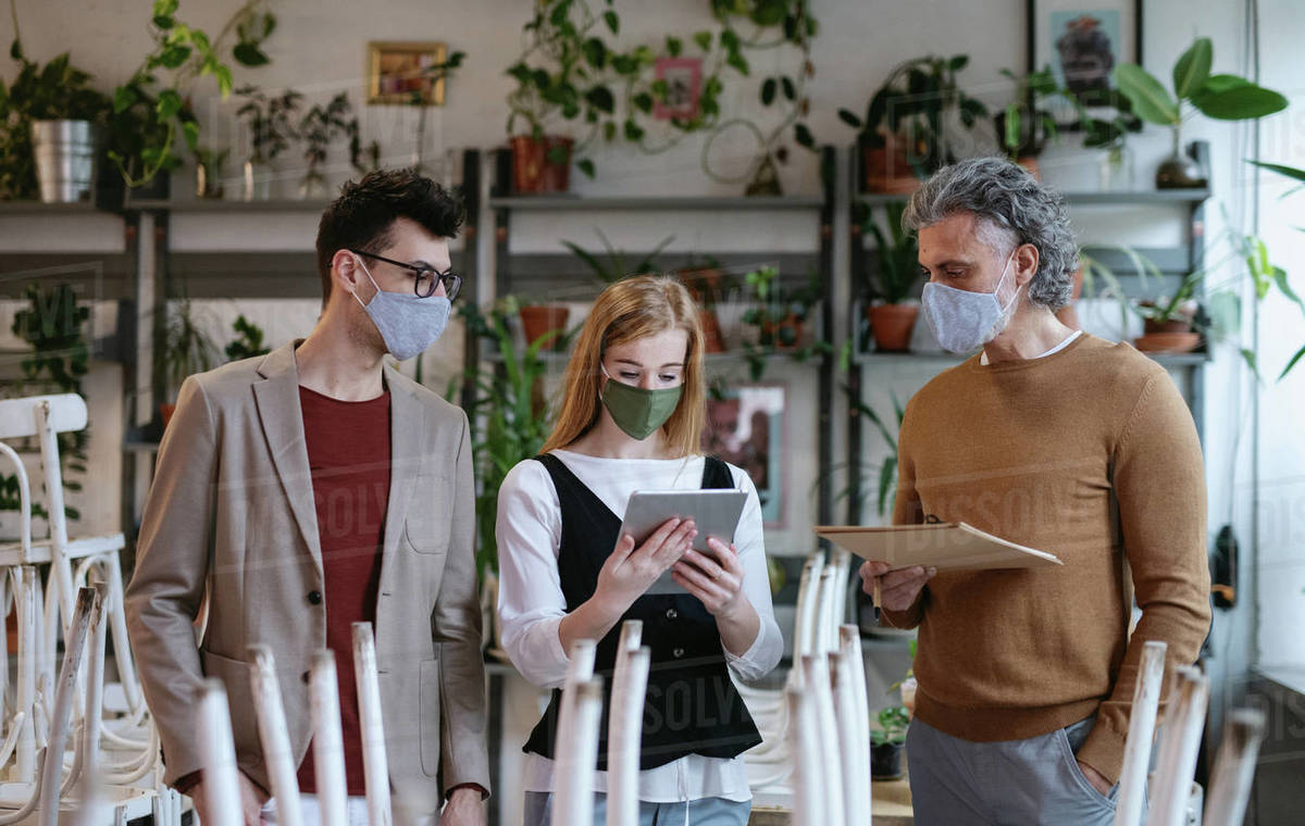 Portrait of men and woman managers in closed cafe, small business ...