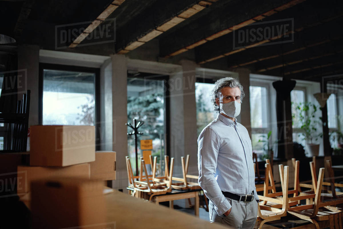 Frustrated owner standing in closed cafe or coffee shop, small business ...