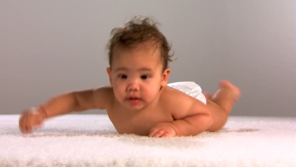 Baby in diaper lifting torso and squirming, chews on fists - HD Royalty ...