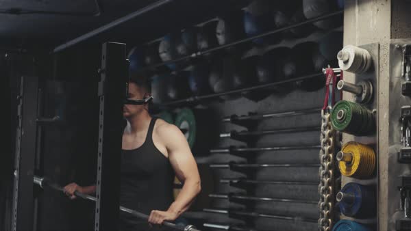 Cinematic wideshot of crossfit athlete loading squat rack - Stock Video ...