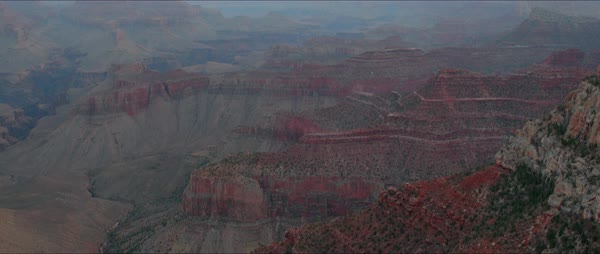 Wide angle/pan down: Grand Canyon's red rocks and green bushes in Grand ...
