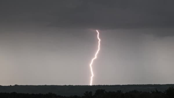 Lightning flash in storm clouds. Heavy clouds bring multiple flashes of ...