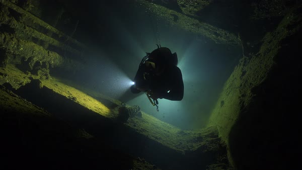 Scuba diver swims inside the shipwreck corridor - Umbria shipwreck, Red ...