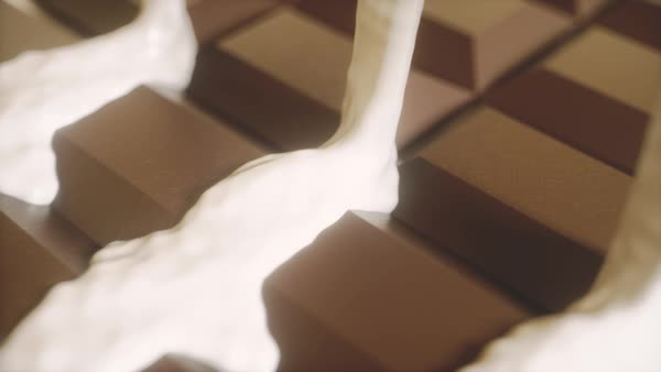 Melted stream milk chocolate pouring over chunks of dark chocolate in ...