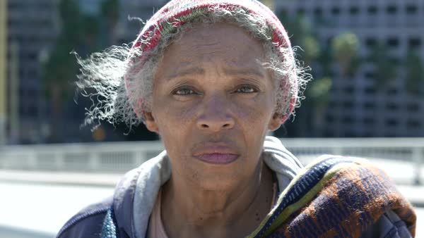 Portrait of an elderly African American homeless woman on the street ...