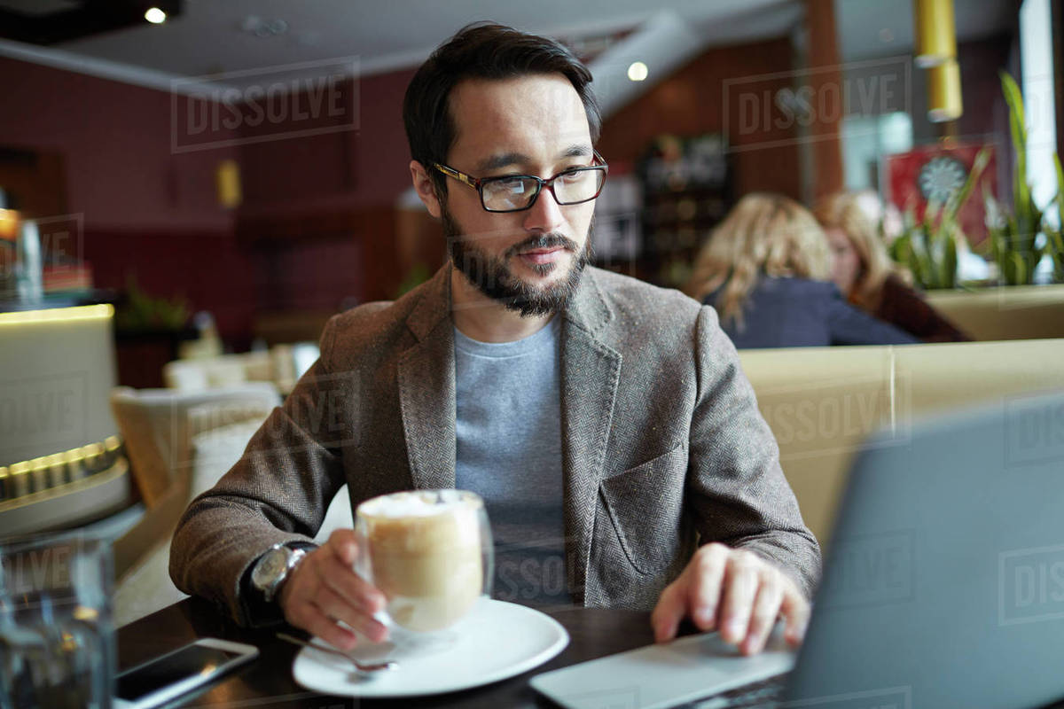 Serious employee networking in cafe - Royalty-free Stock Photo | Dissolve