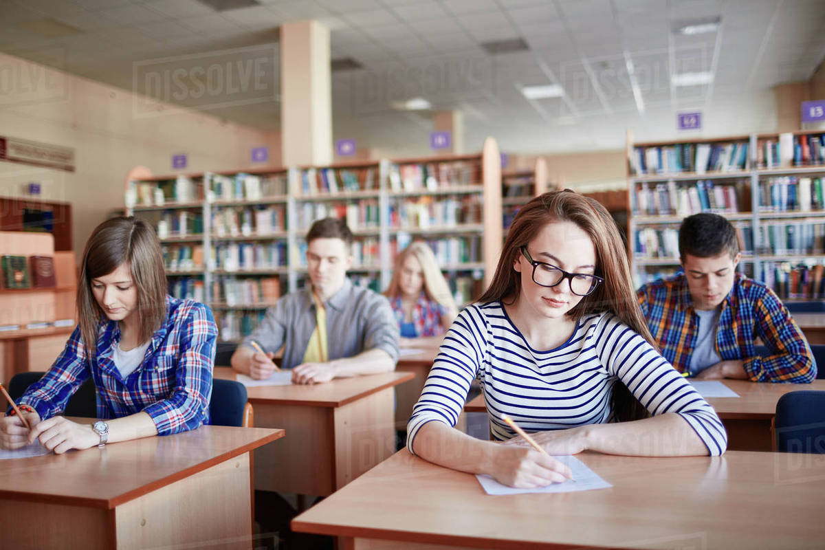 Serious student writing test at college - Royalty-free Stock Photo ...