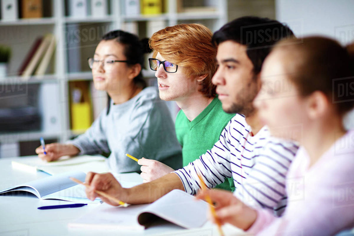 Row of students sitting at lecture in college - Stock Photo - Dissolve