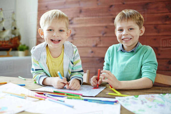 Two happy boys drawing with highlighters - Stock Photo - Dissolve