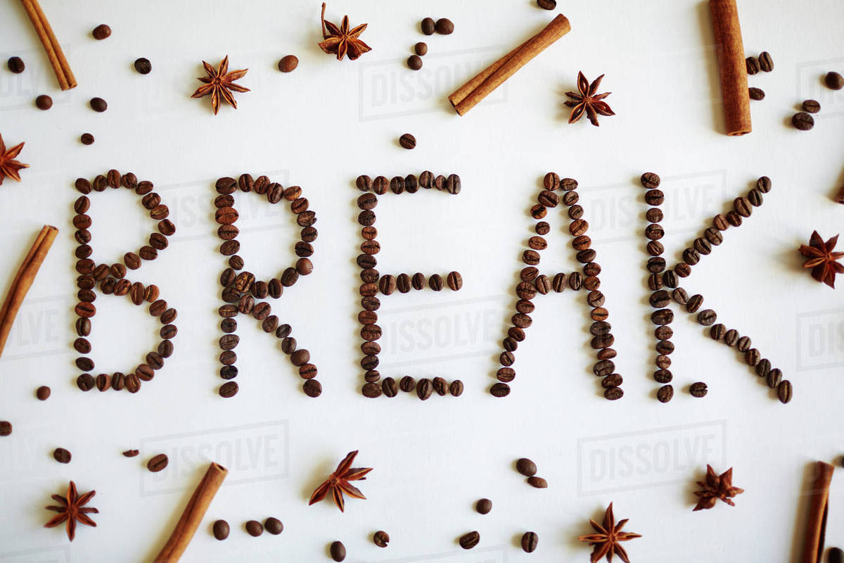 Word 'break' made up of coffee grains surrounded by star anise and ...