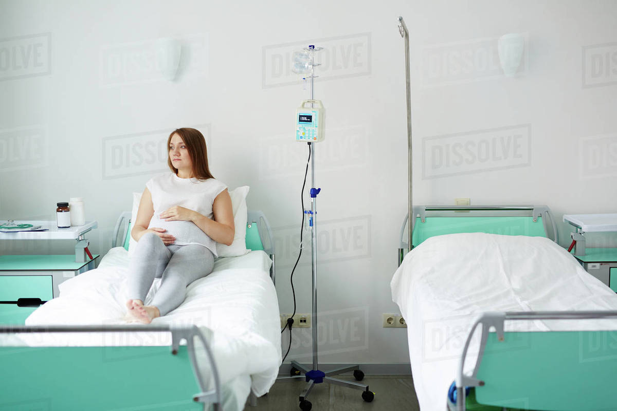 Young woman lying on bed in prenatal center - Royalty-free Stock Photo ...