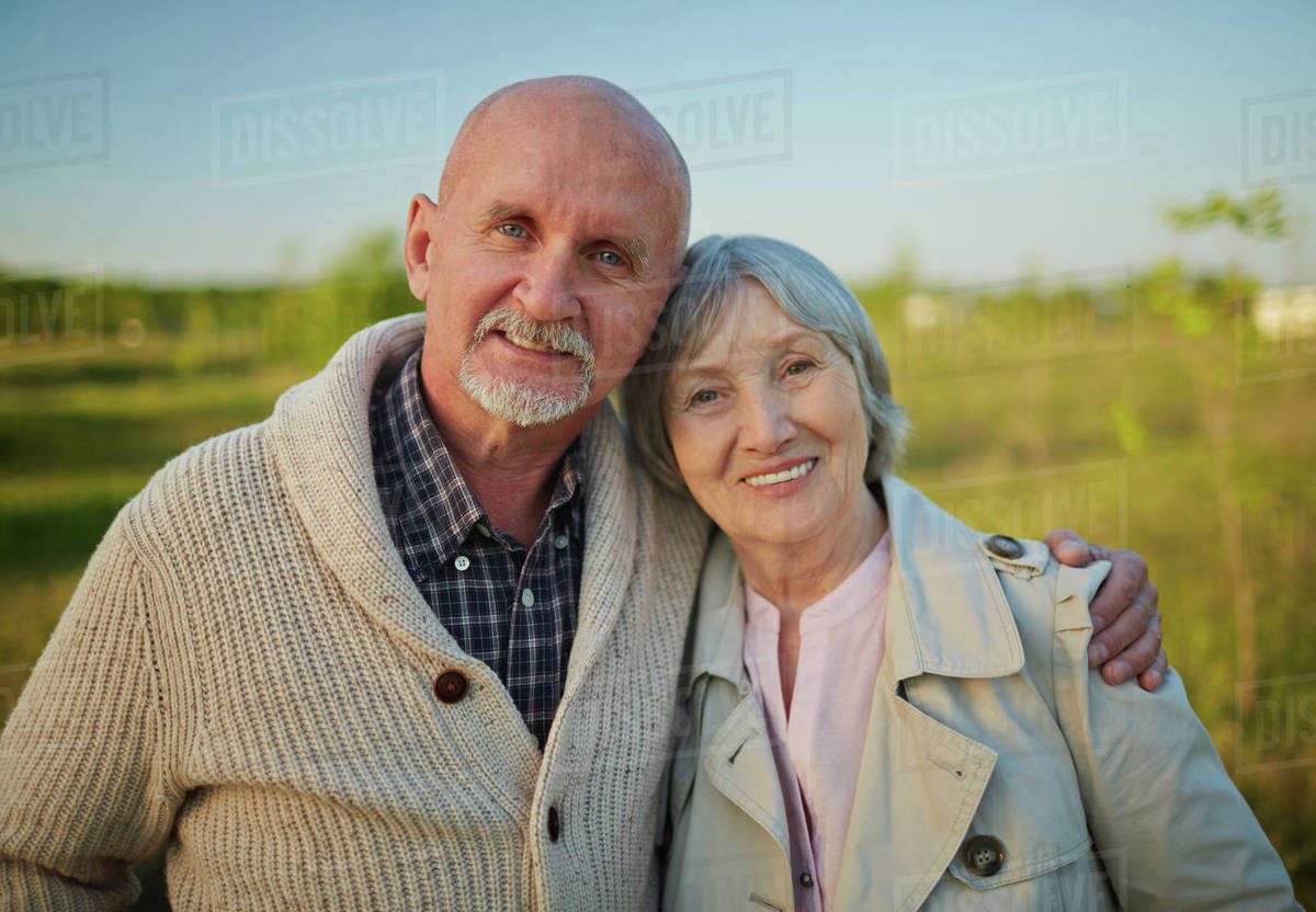 Seniors looking at camera with smiles in the countryside - Stock Photo ...