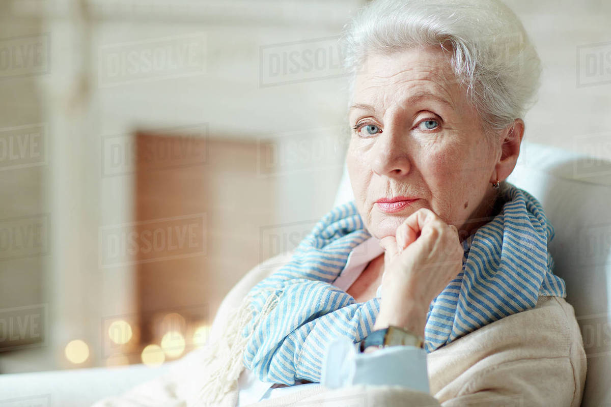 Serious grandmother looking at camera - Royalty-free Stock Photo | Dissolve