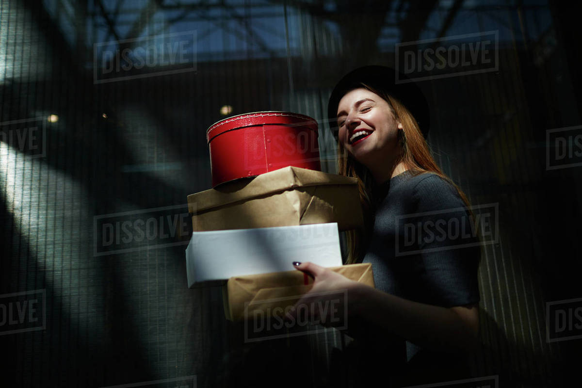 Laughing shopper carrying stack of boxes - Royalty-free Stock Photo ...