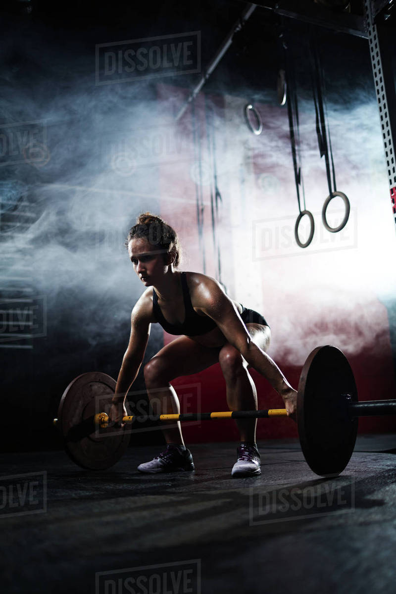 Woman lifting heavy weight during workout - Royalty-free Stock Photo ...