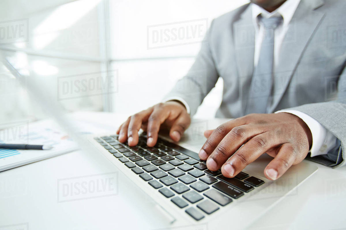 Businessman tapping at a laptop keyboard - Royalty-free Stock Photo ...