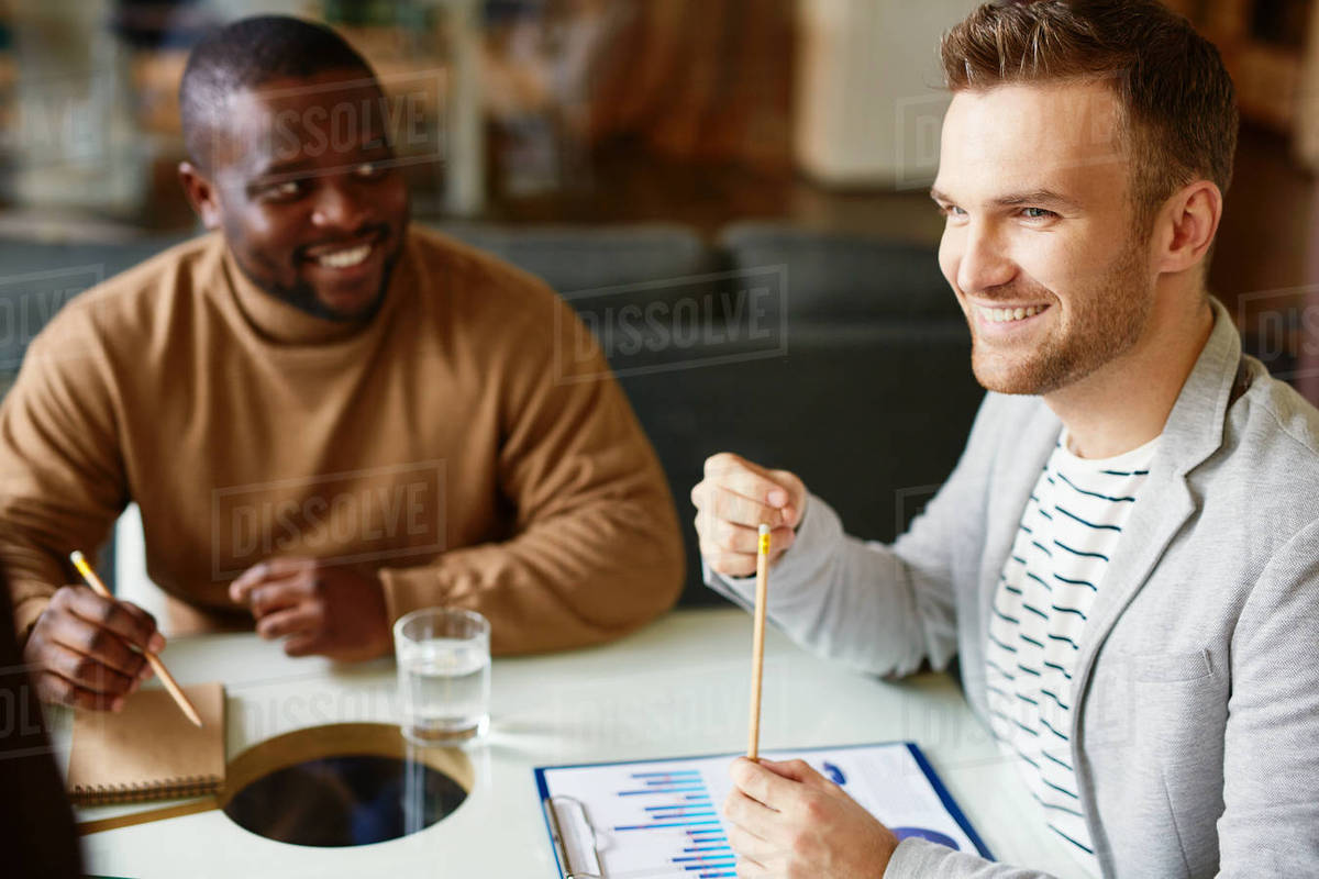 Two businessmen communicating with colleagues - Stock Photo - Dissolve