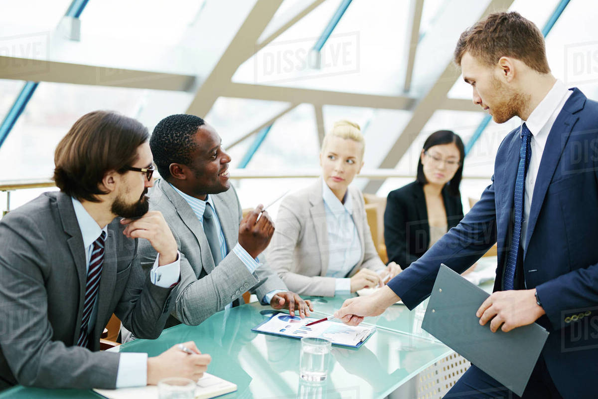 Managers discussing data at meeting - Royalty-free Stock Photo | Dissolve