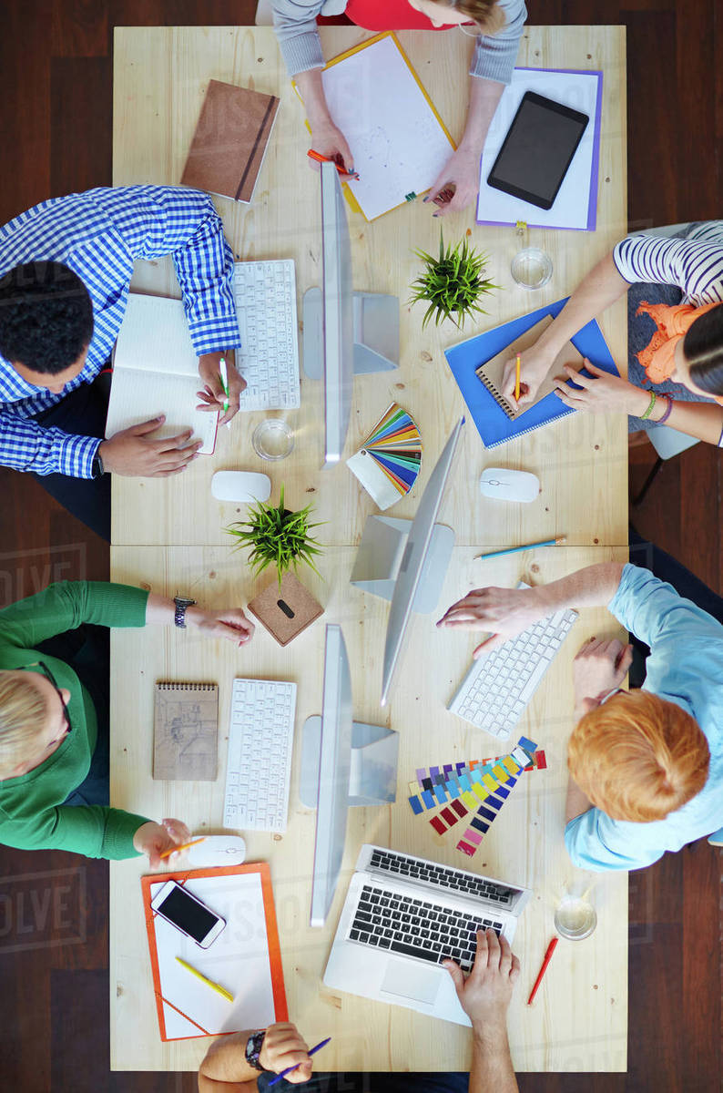 Group of young designers working by table in office - Royalty-free ...