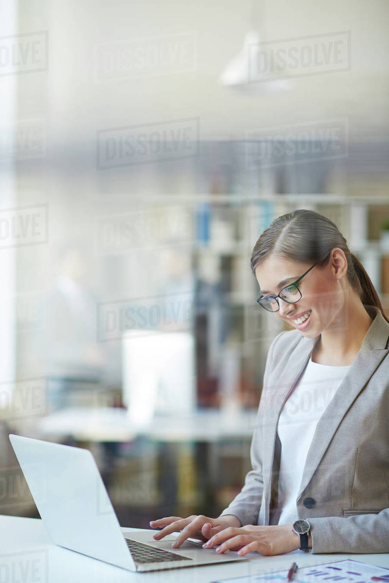 Successful young secretary typing at workplace in office - Royalty-free ...