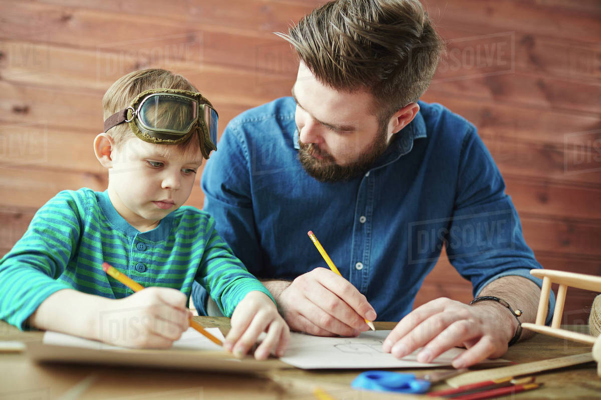 Young man and his son drawing sketch - Royalty-free Stock Photo | Dissolve