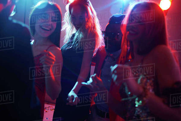 Posh young people dancing at party - Royalty-free Stock Photo | Dissolve