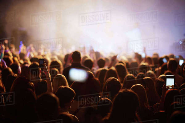 Crowd at a concert shot from behind - Royalty-free Stock Photo | Dissolve