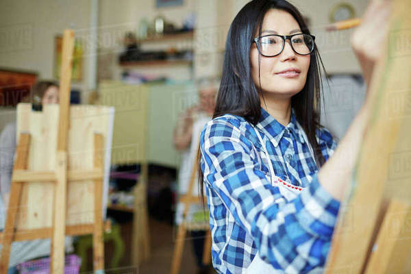 Young woman learning to paint in art class - Royalty-free Stock Photo ...