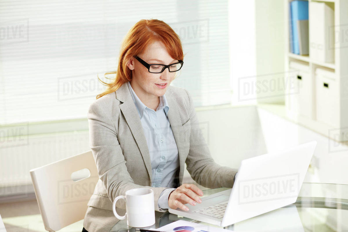 Young female manager working in office - Royalty-free Stock Photo ...