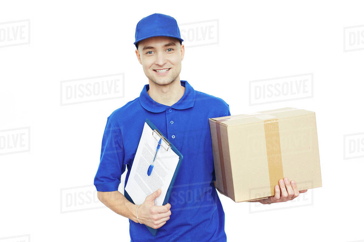 Happy courier with parcel and delivery document looking at camera ...
