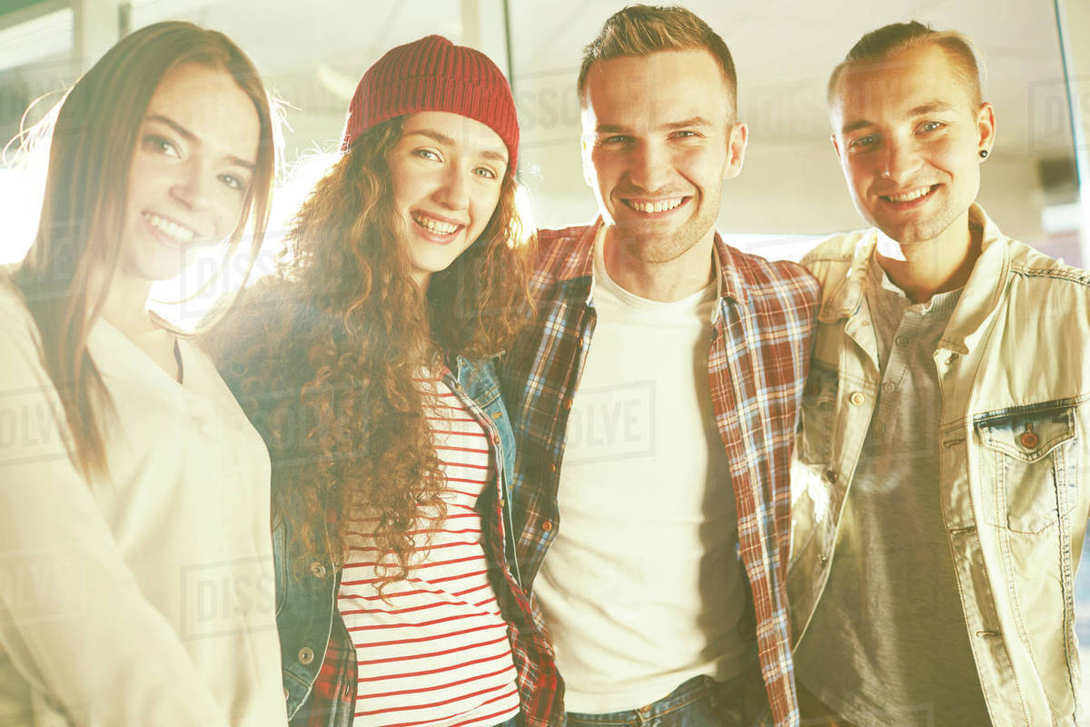 Portrait of four stylish teenagers smiling at camera - Royalty-free ...