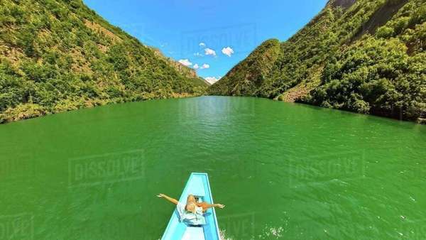 Woman on a boat traversing the mesmerizing Albanian Alps, the Shala ...