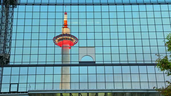 TIME LAPSE: Kyoto Tower with observation deck, reflects on glass facade ...
