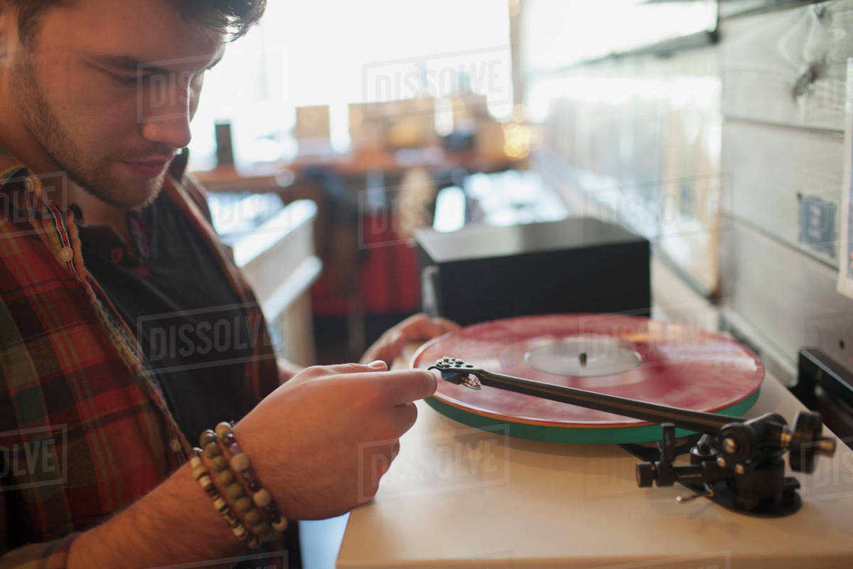 Young man listening to a record. - Royalty-free Stock Photo | Dissolve