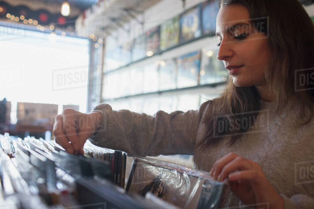 Young woman in a record store. - Royalty-free Stock Photo | Dissolve