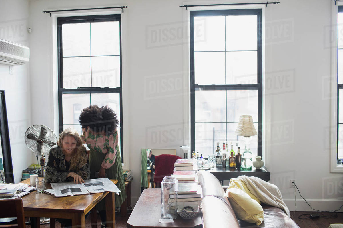 A young couple at a dining table - Royalty-free Stock Photo | Dissolve