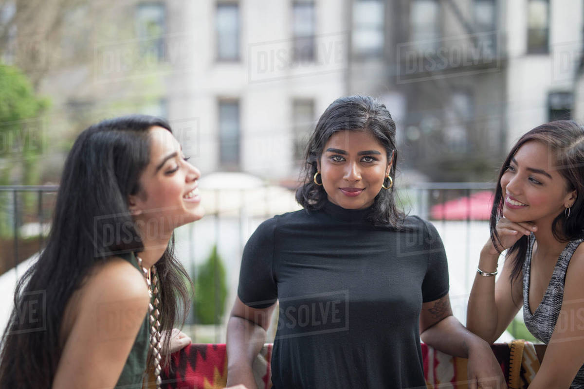 Young women talking at a party - Stock Photo - Dissolve