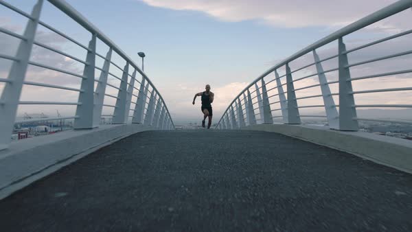 Muscular young man running athlete sprinting fast intense workout ...