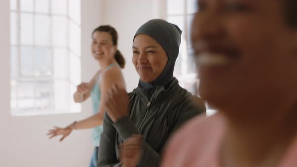 Happy muslim woman dancing group of healthy people enjoying workout ...