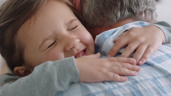Grandfather hugging granddaughter happy little girl embracing grandad ...