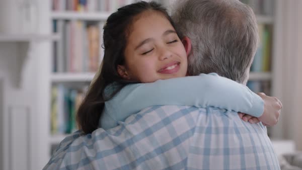Grandfather hugging granddaughter happy little girl embracing grandad ...