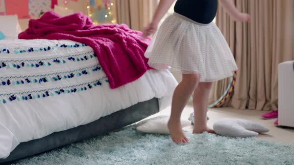 Happy teenage girl dancing in bedroom wearing ballet tutu having fun ...