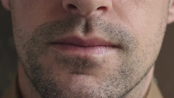 Close up caucasian man mouth unshaved facial hair stubble serious ...
