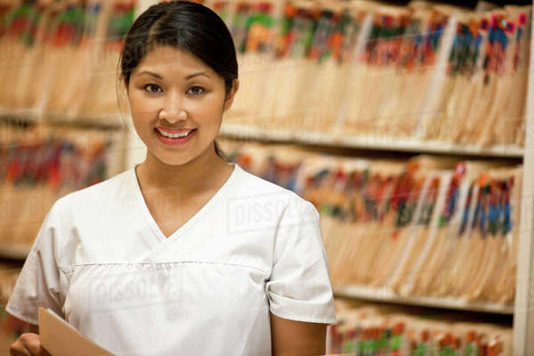 Portrait of nurse holding the folder in hospital office. - Stock Photo ...